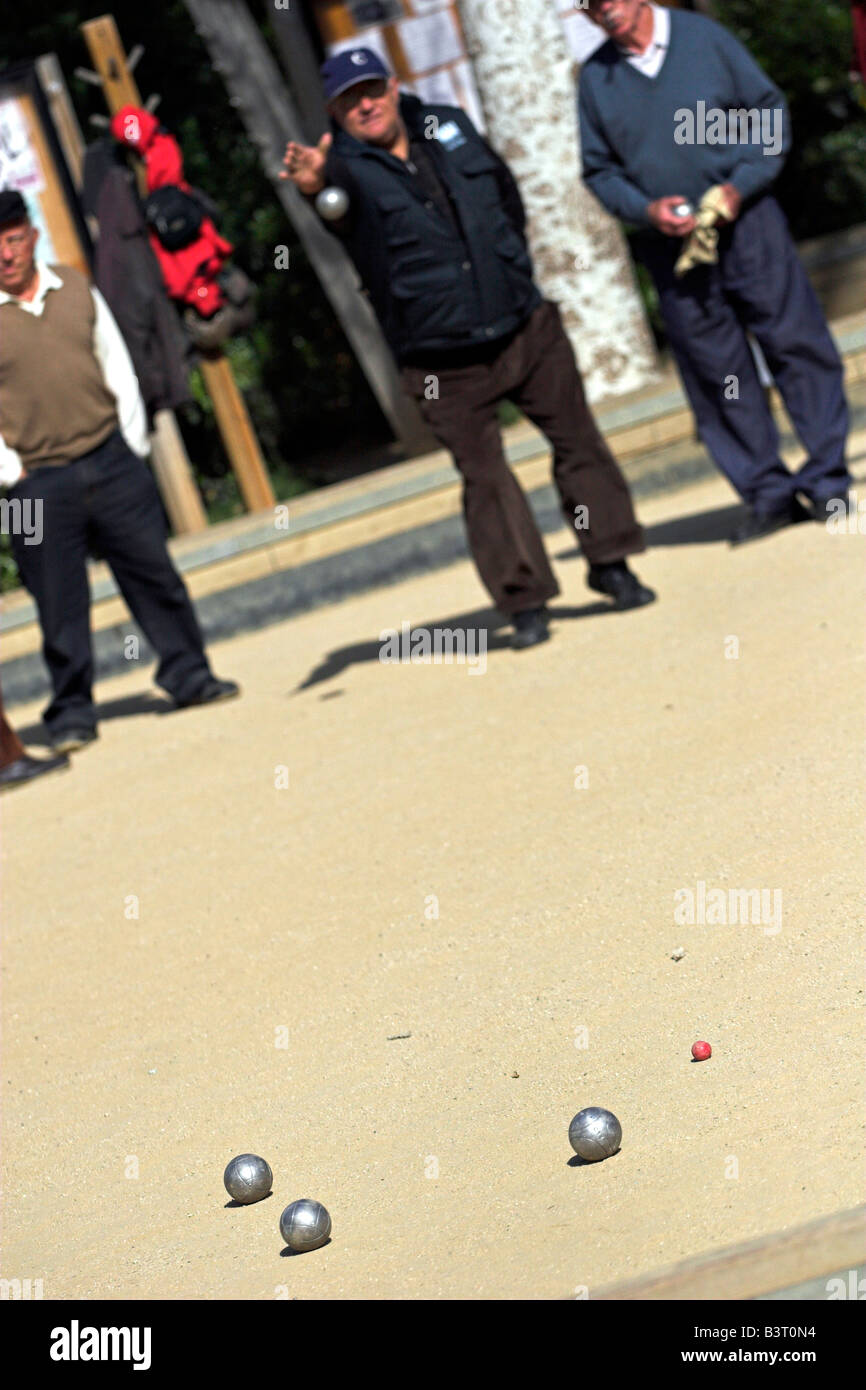 Several older gentleman play Bocce in a public courtyard in Barcelona ...