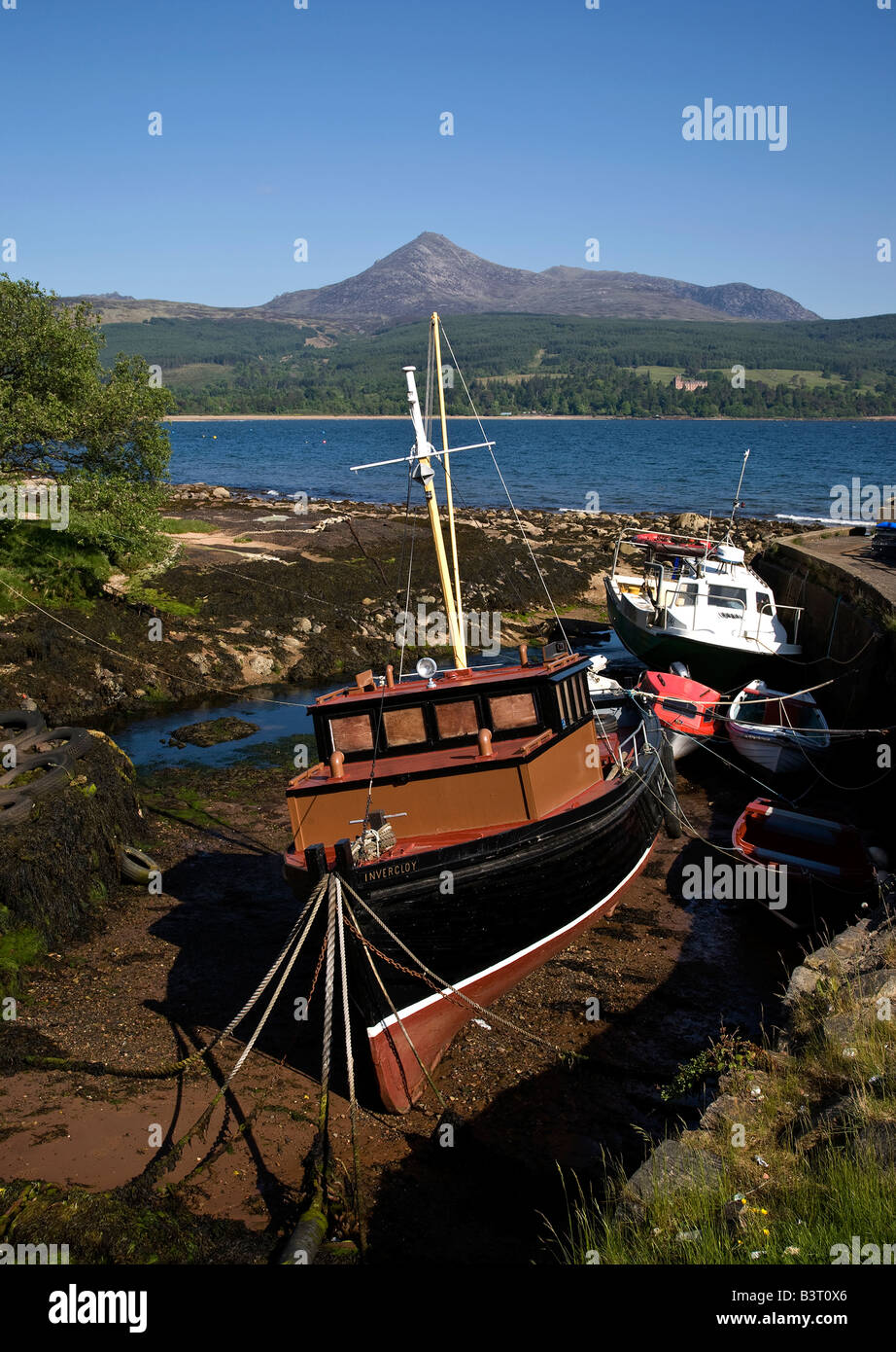 Boats lie in an inlet on Brodick beach on the Isle of Arran in south ...