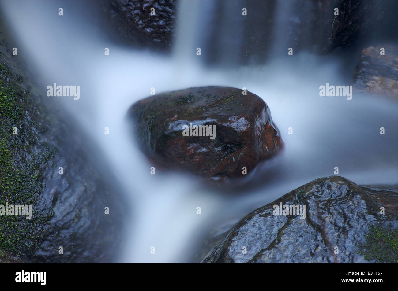 20 second exposure of water running around a rock in a stream Stock ...