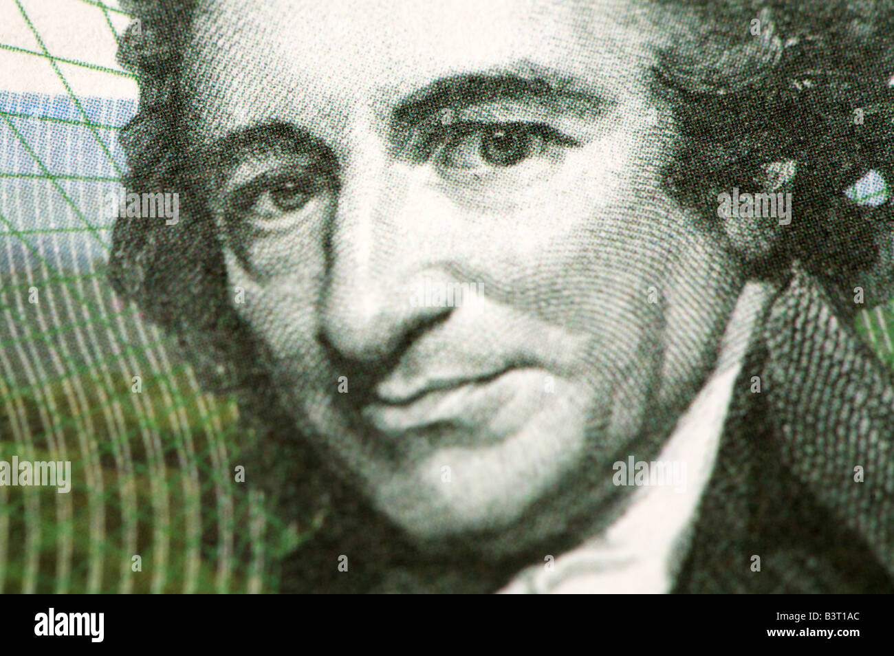 A macro photograph of the face of Thomas Paine on a Lewes pound note ...