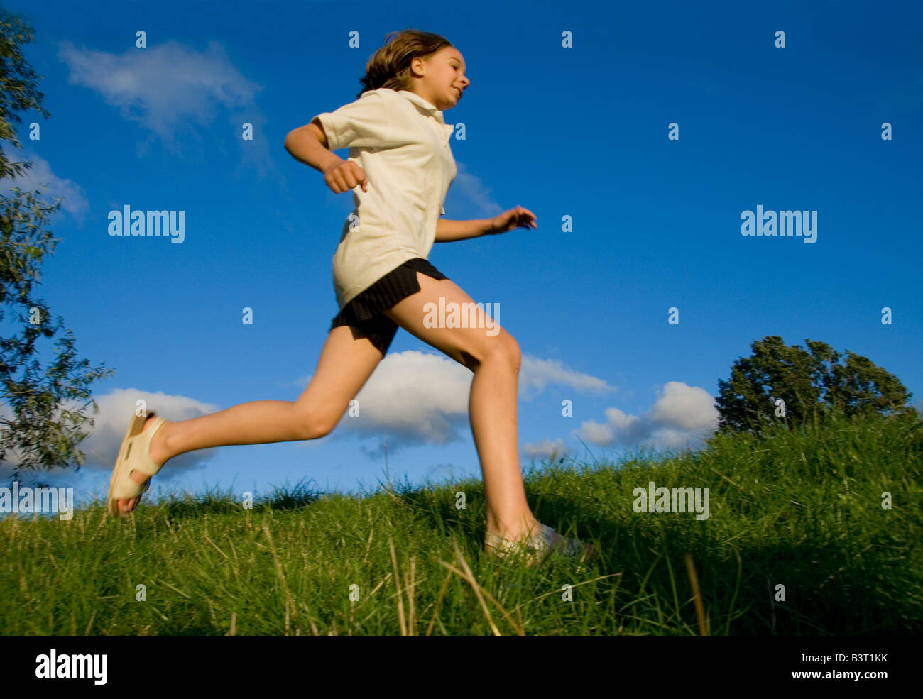 girl child running along parkland Stock Photo - Alamy