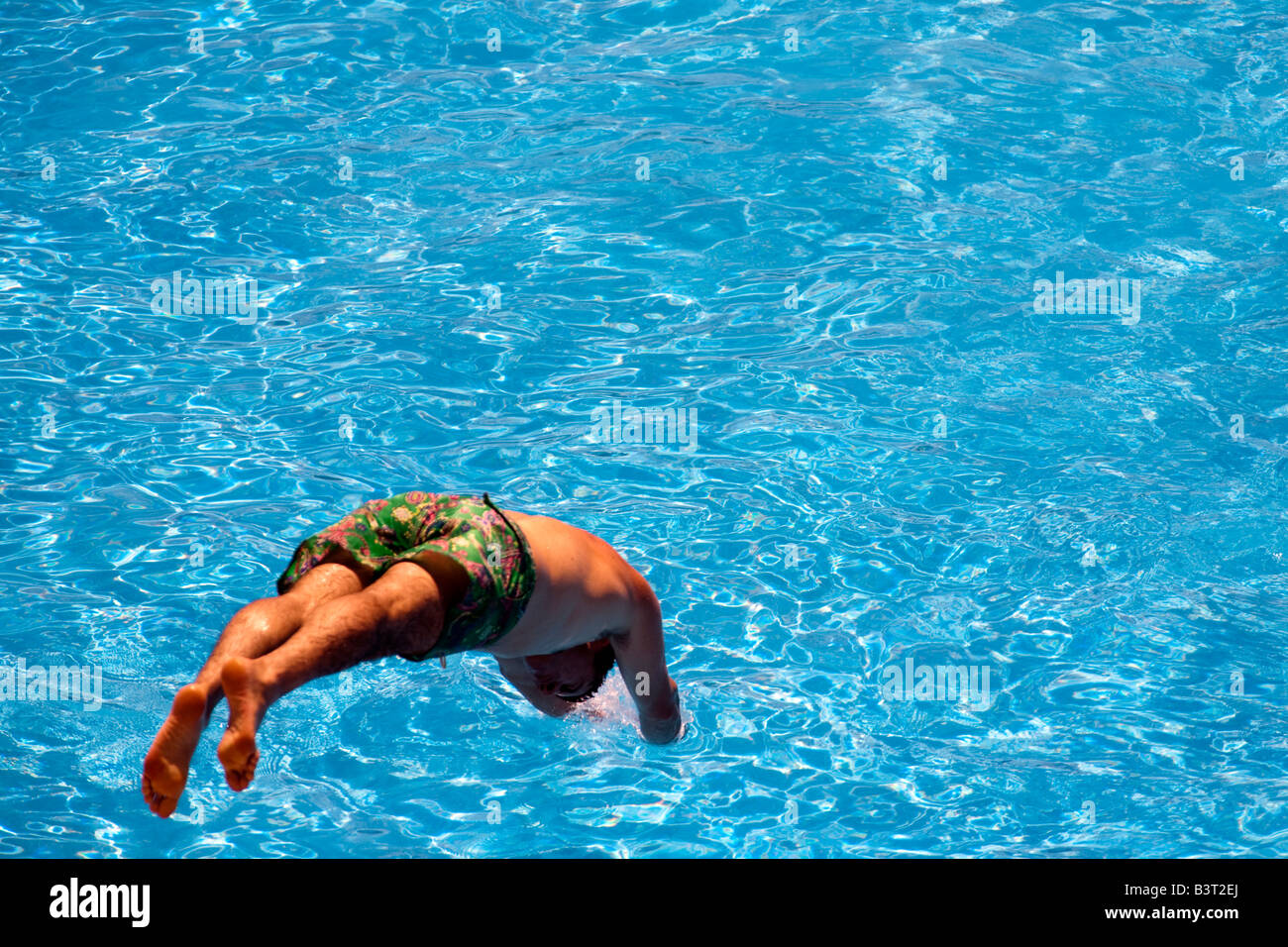 Man diving into a swimming pool Stock Photo - Alamy