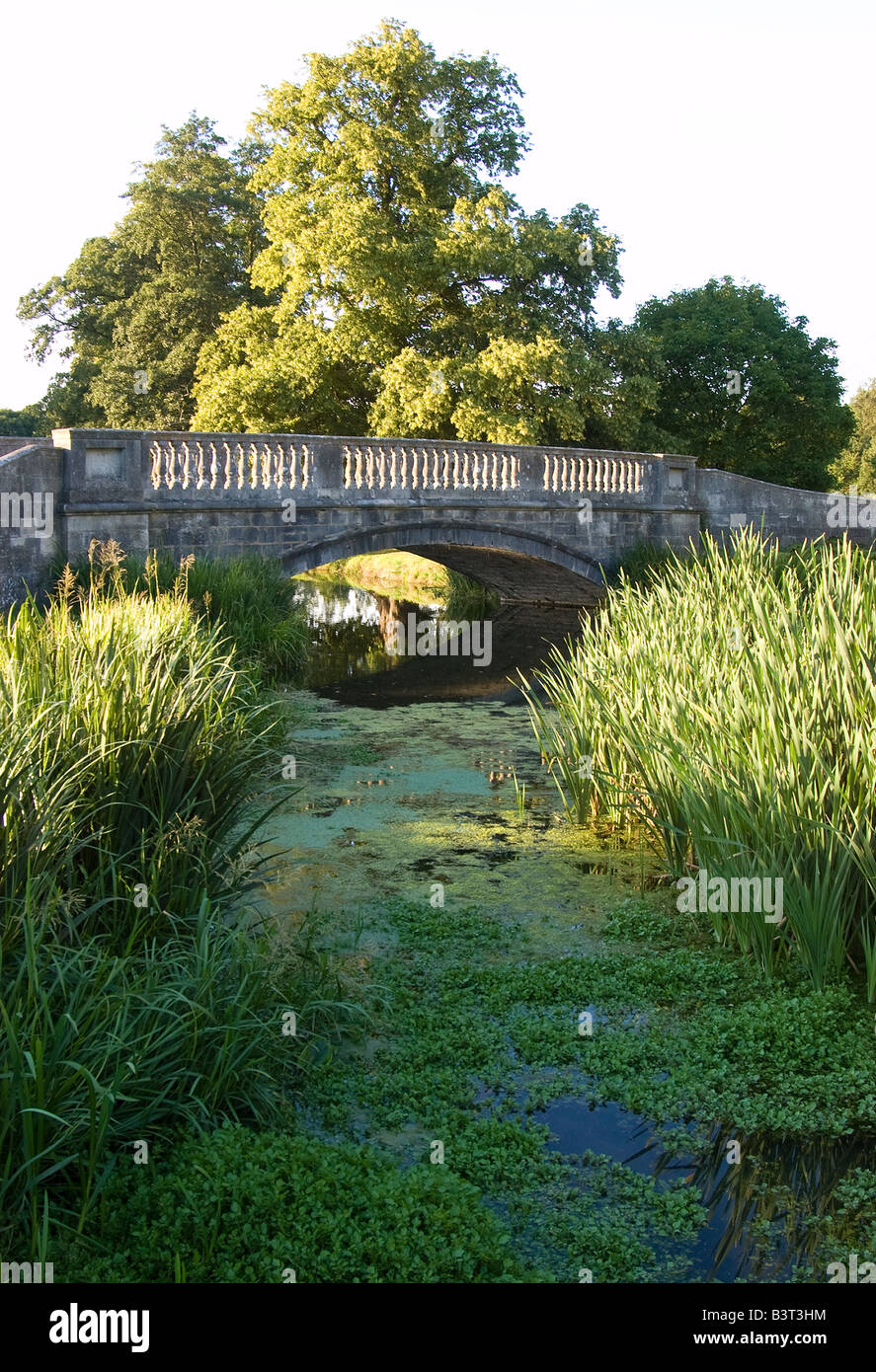 Stone bridge over slow moving river, UK Stock Photo - Alamy