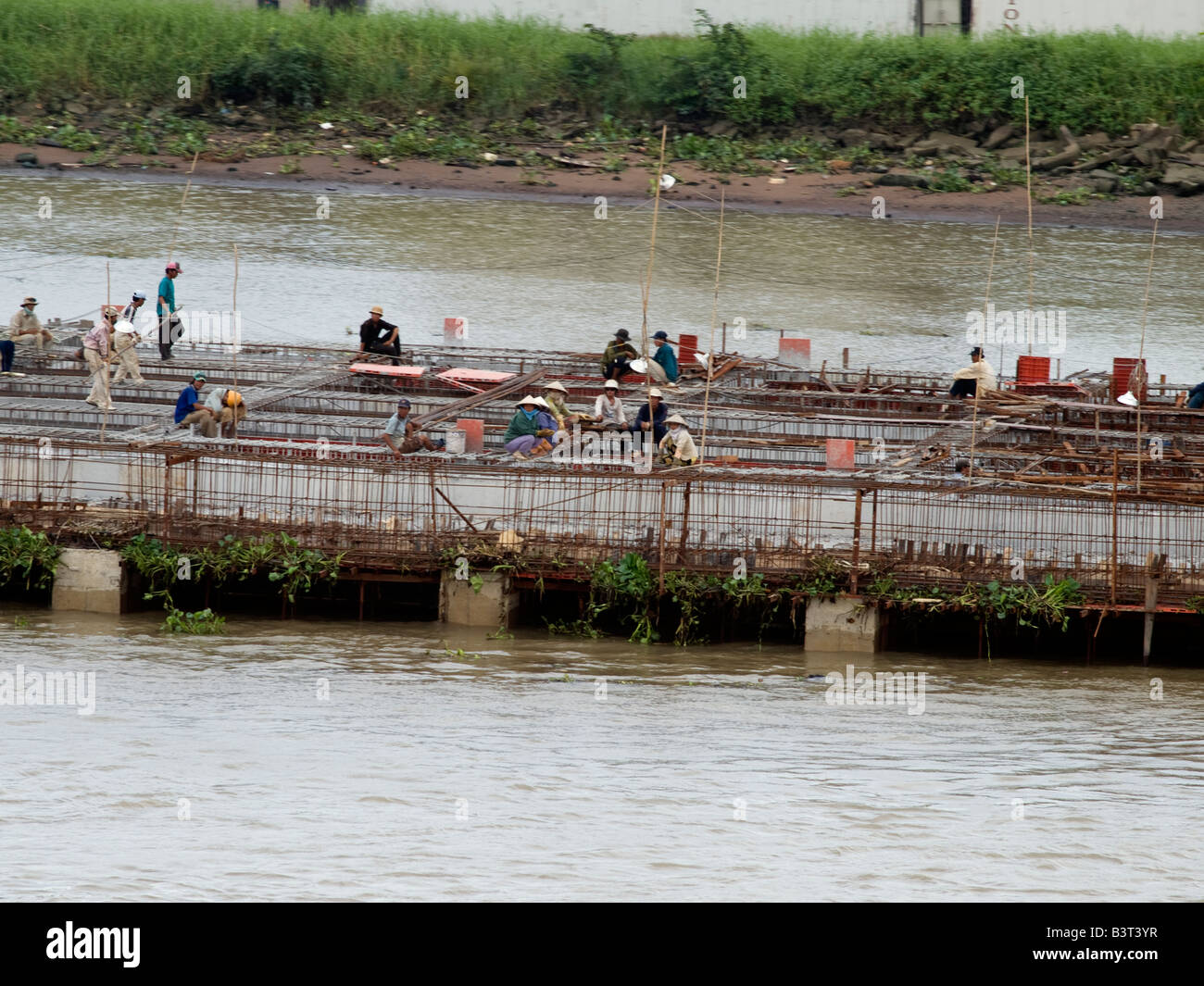 Men working at the riverside Stock Photo - Alamy