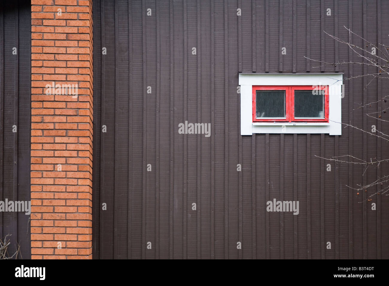 A brown wall with a brick chimney stack and a red window Stock Photo ...