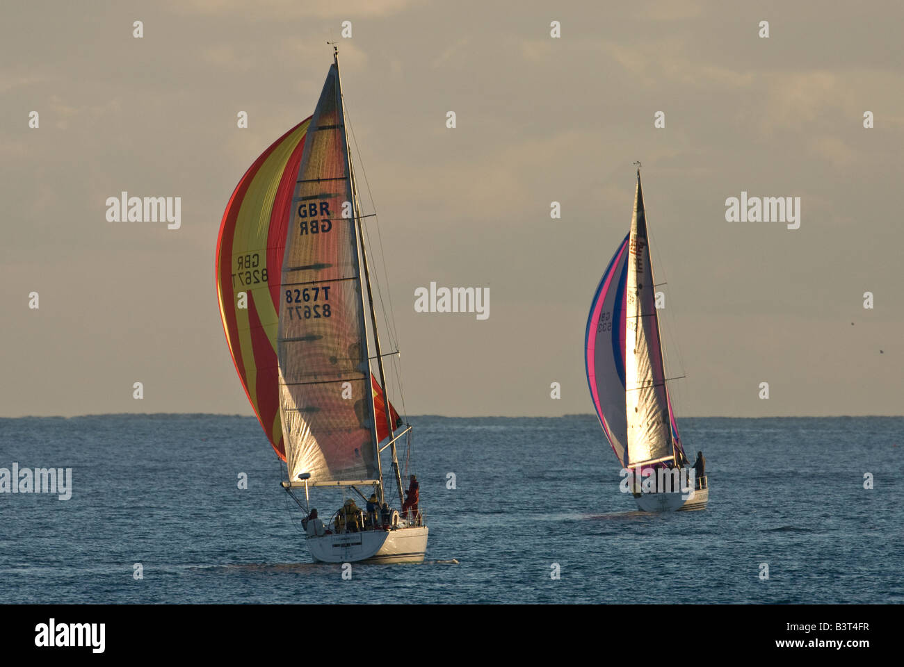 2 yachts sailing with colourful sails in calm conditions Stock Photo ...