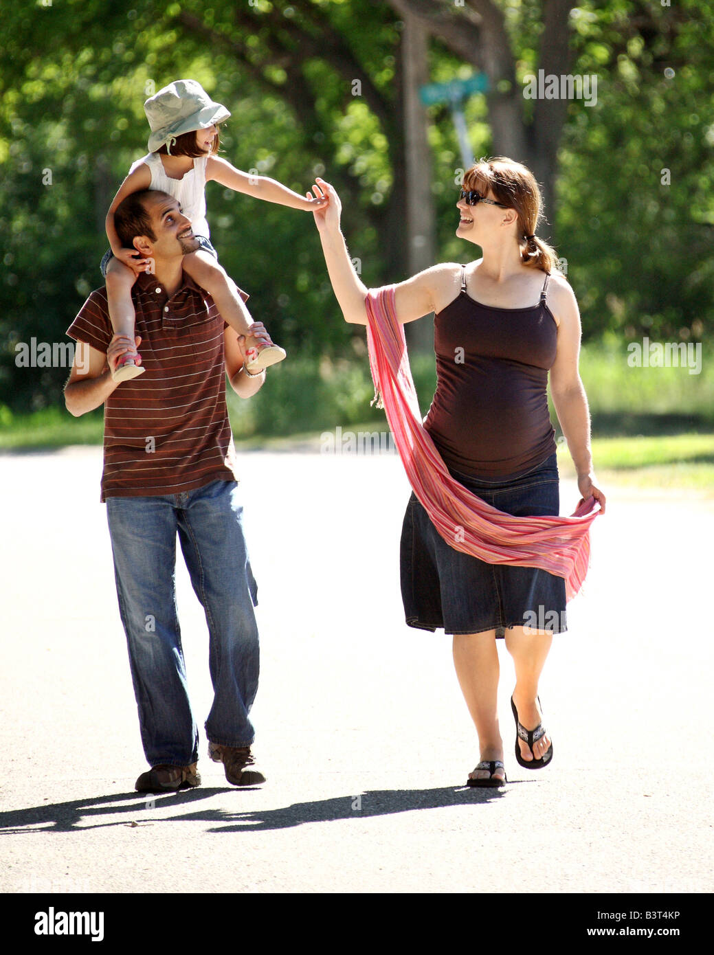 Family out for a walk in the park Stock Photo - Alamy