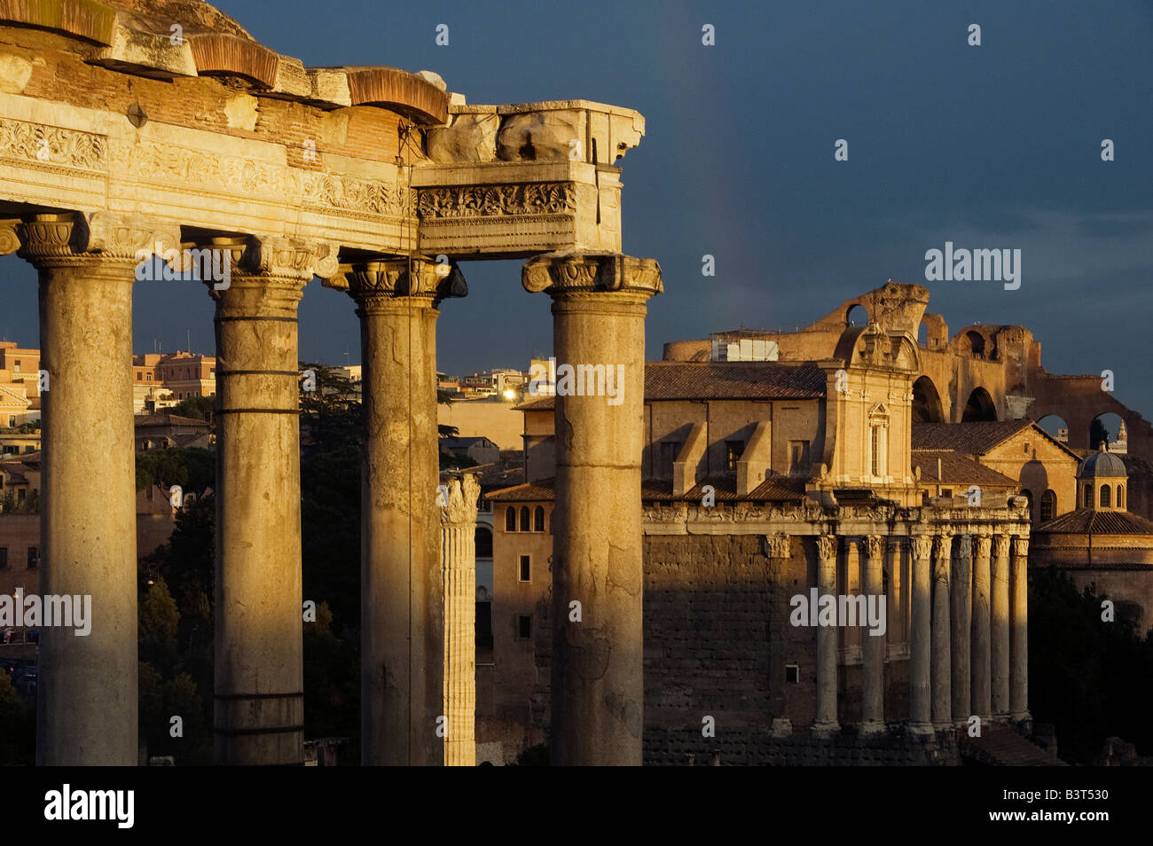 columns of Temple of Saturn with Saint Luca and Martina Church at the ...