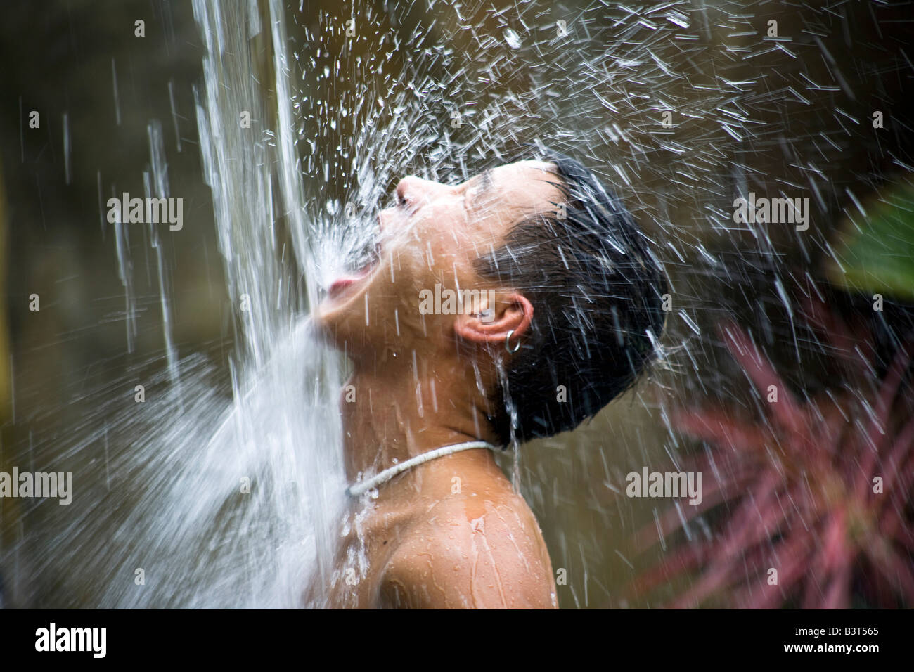 Man under waterfall Stock Photo - Alamy