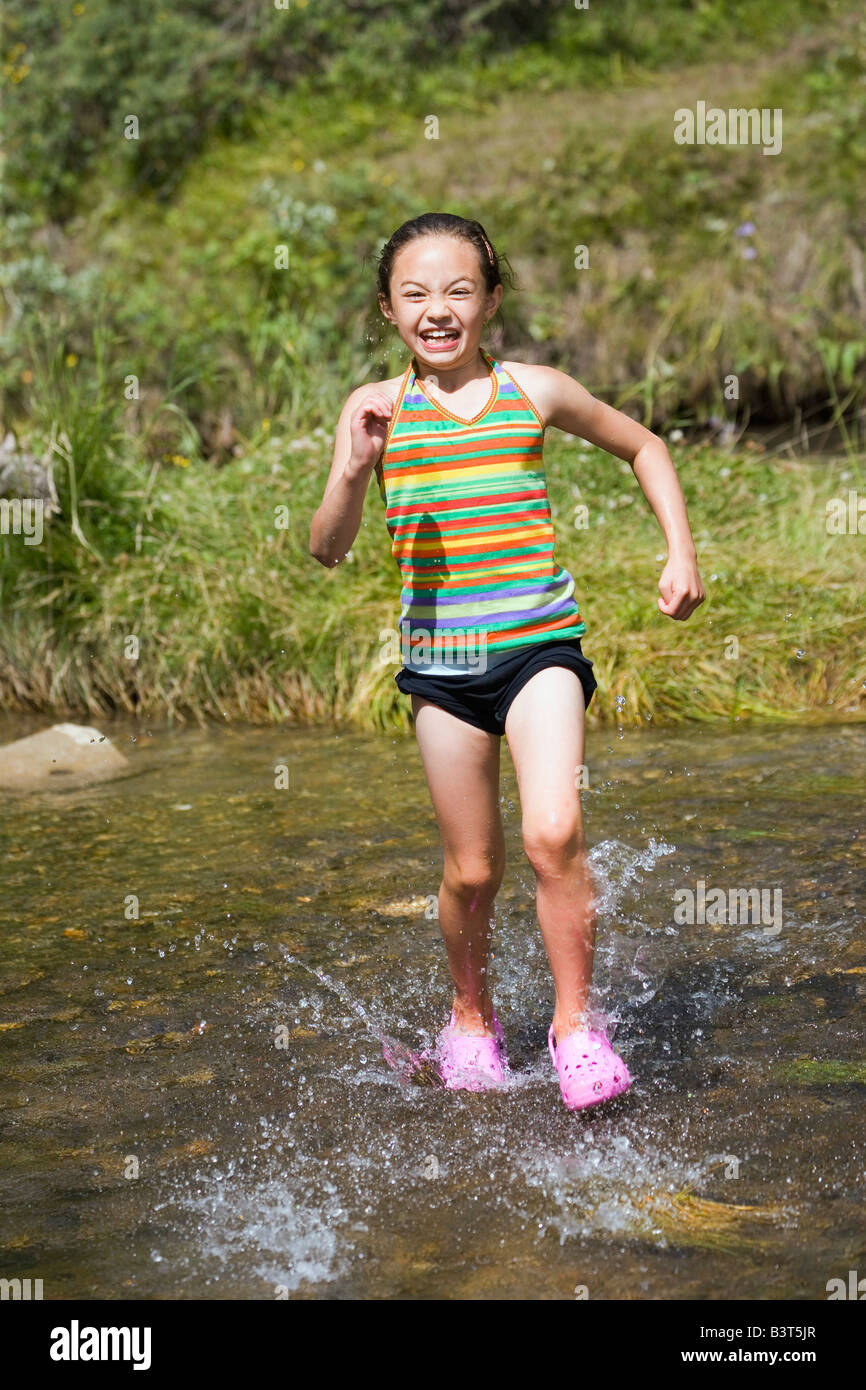 Girl running in water Stock Photo - Alamy
