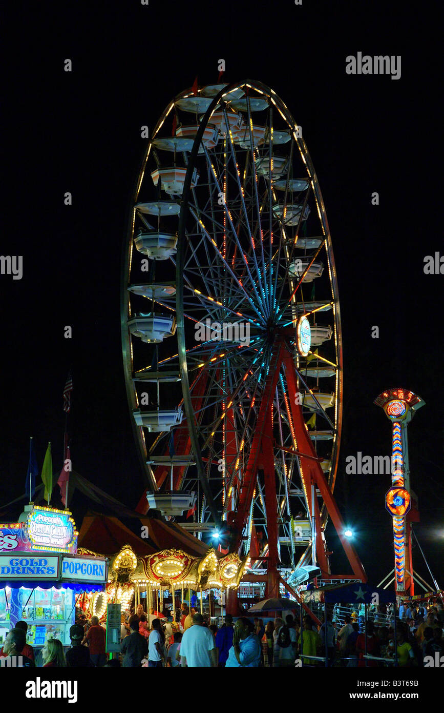 A ferris wheel lit brightly during night time activities at a County ...
