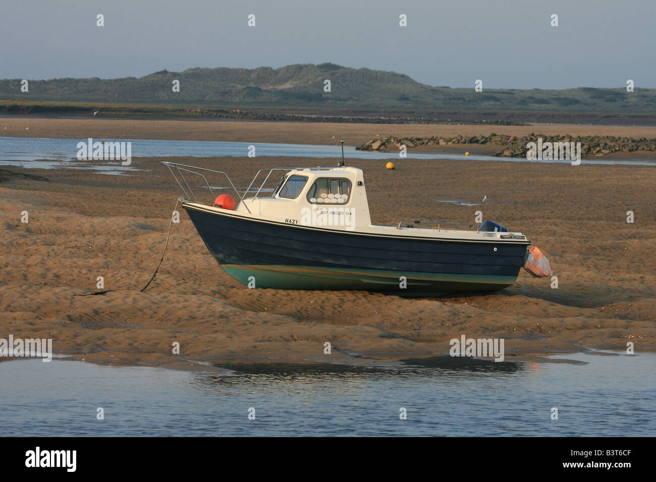 Boat on a sandbank Stock Photo - Alamy