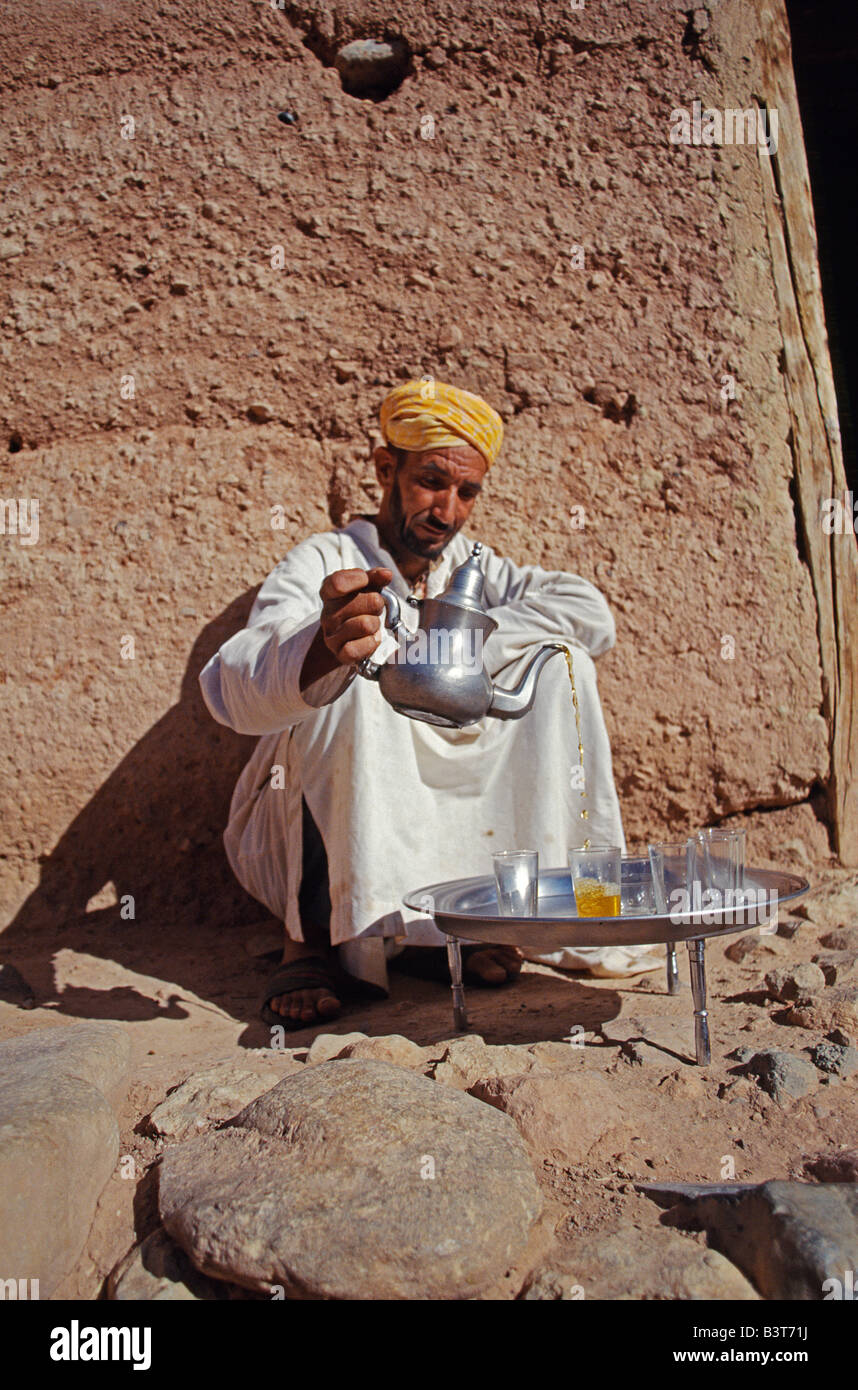 Morocco. A berber man pours mint tea in an elaborate, timeless ritual ...