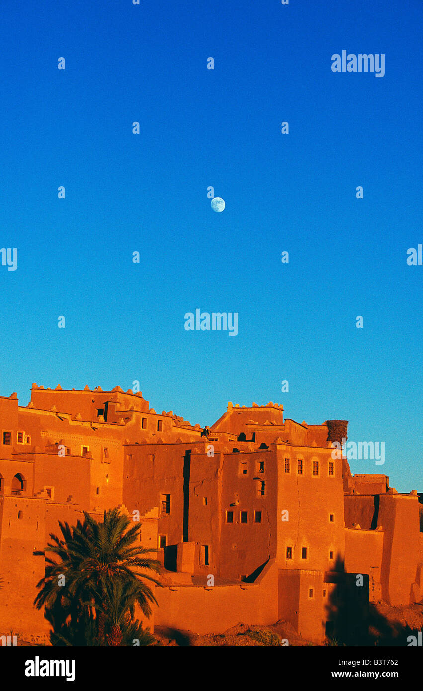 Moonrise over the castellated tower of the Taourirt Kasbah at sunset ...