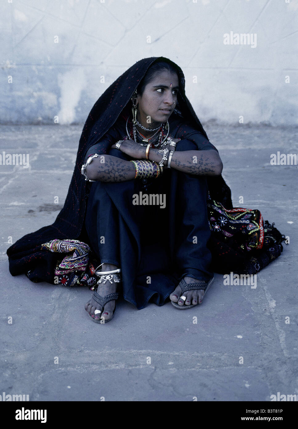 India, Gujarat, Kutch. A Rabari woman sits at Than Monastery. Rabari ...