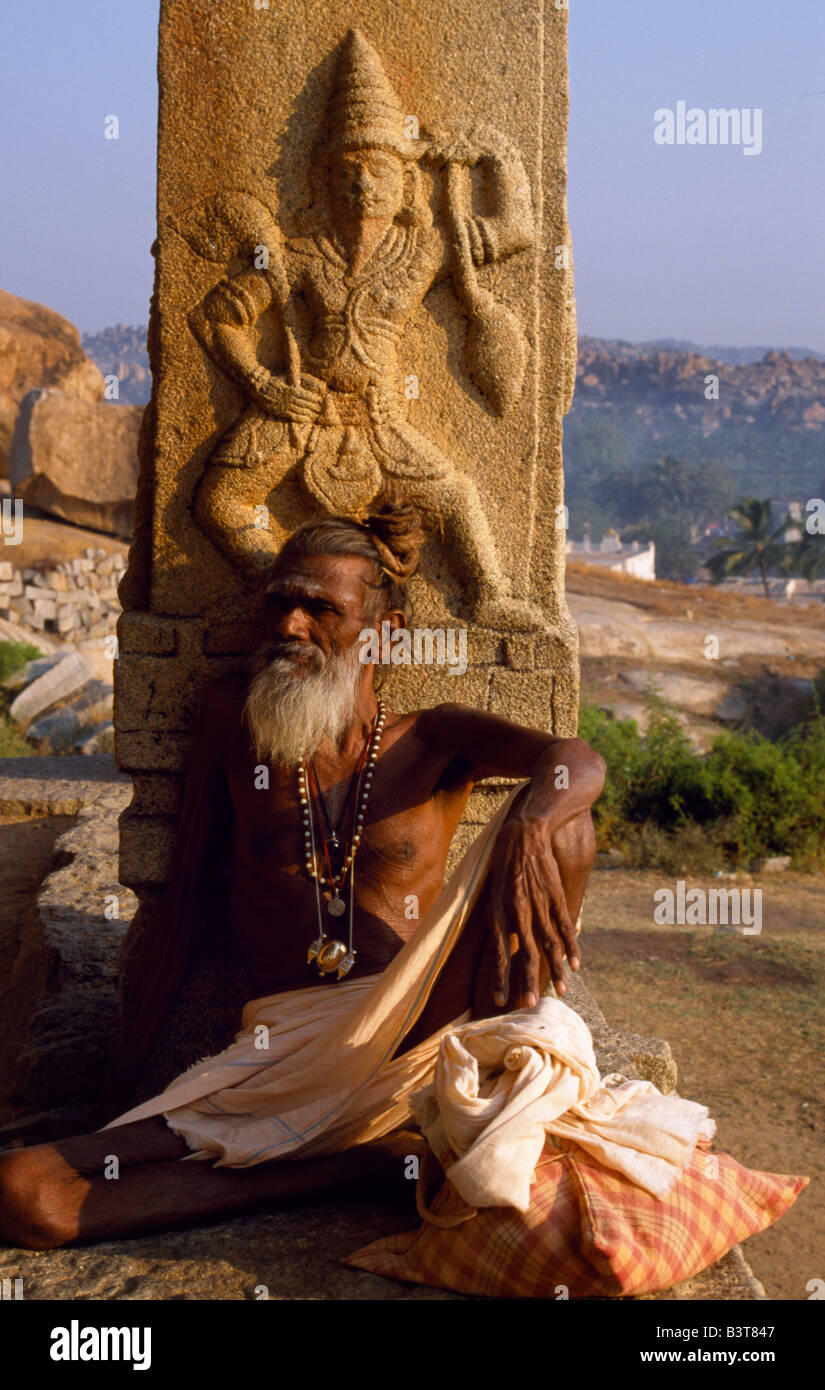 India, Karnataka, Hampi. A wandering ascetic or sadhu, rests in the ...
