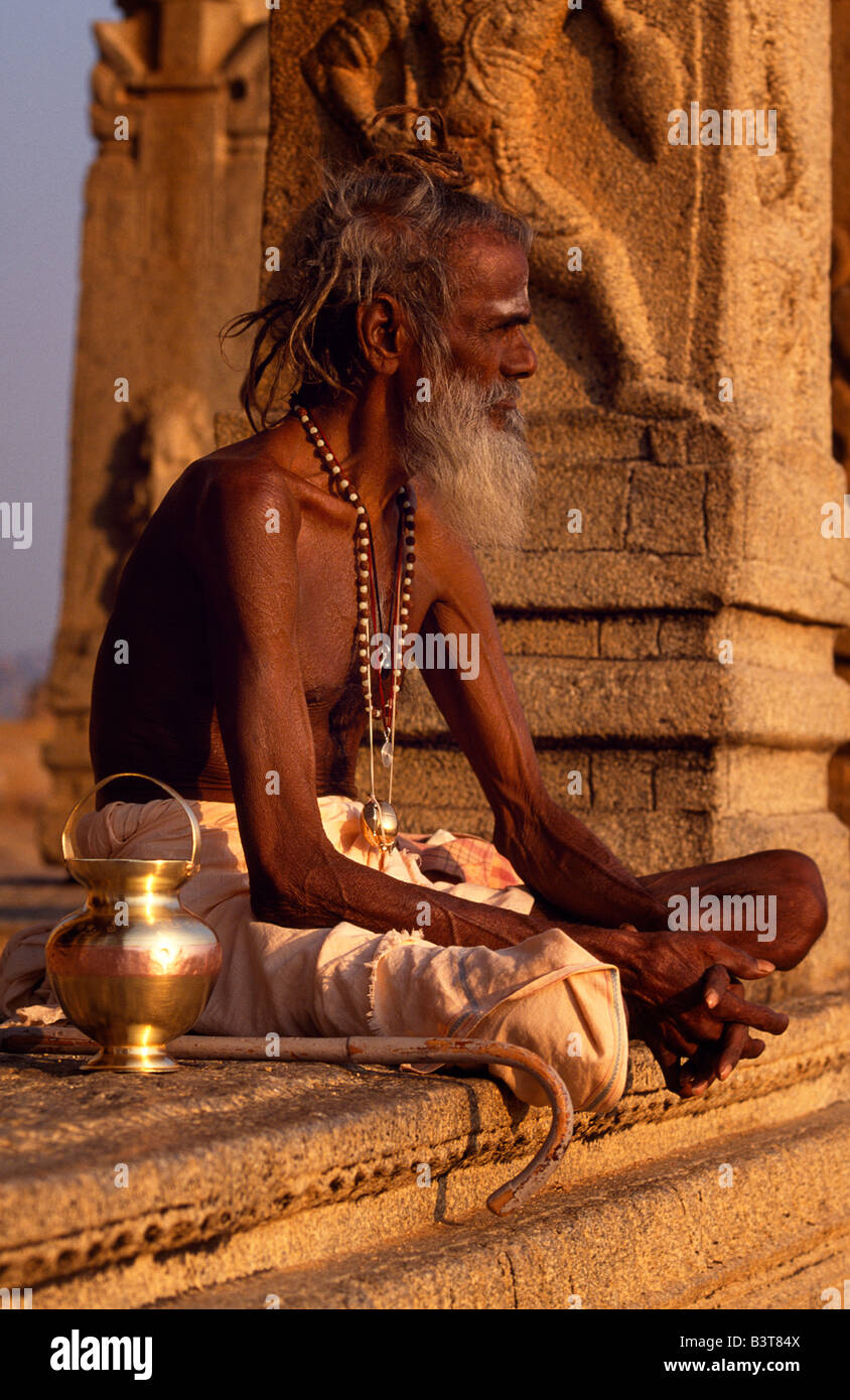 India, Karnataka, Hampi. A wandering ascetic or sadhu, rests in the ...