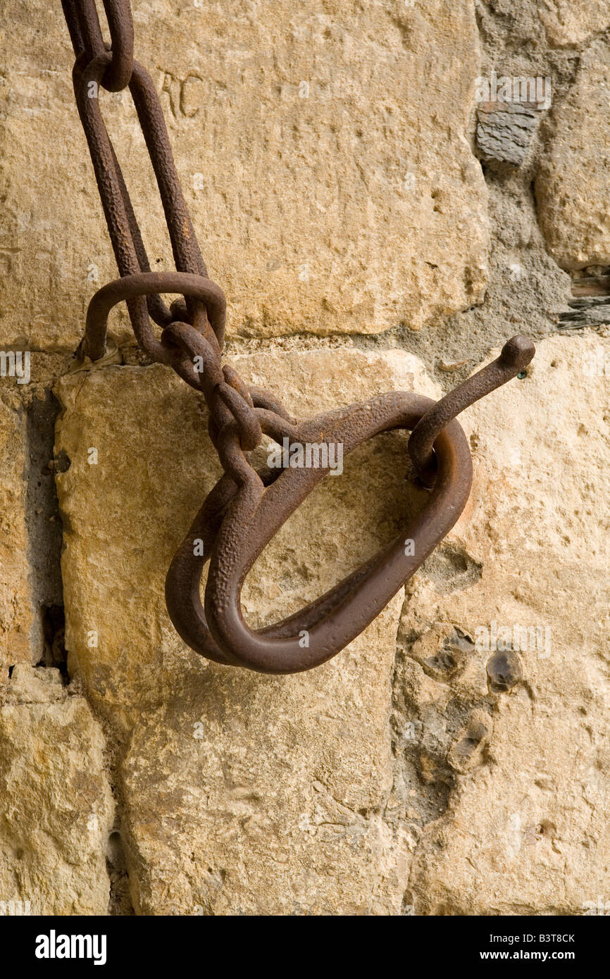 rusty chain hooked up on an old stone wall of Angers Castle in the ...