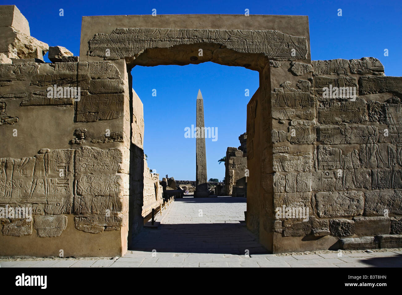 Obelisk of Thutmose I framed by doorway covered in hierglyphs, Temple ...