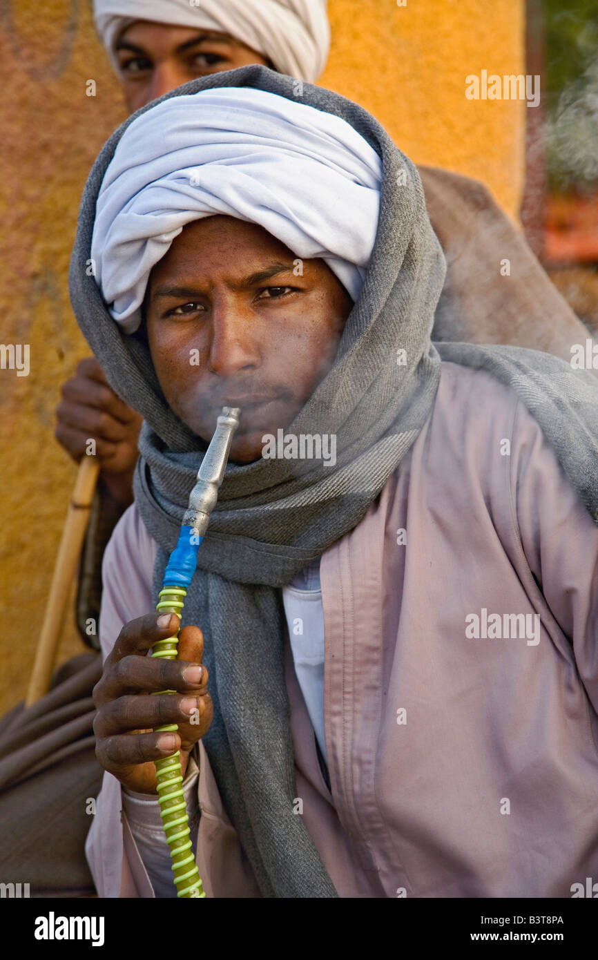 Egyptian man at Camel market smoking hookah pipe, Cairo, Egypt Stock ...