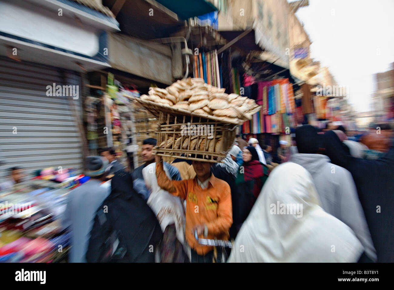Blurred motion effect, young man carrying bread through Khan el Khalili ...