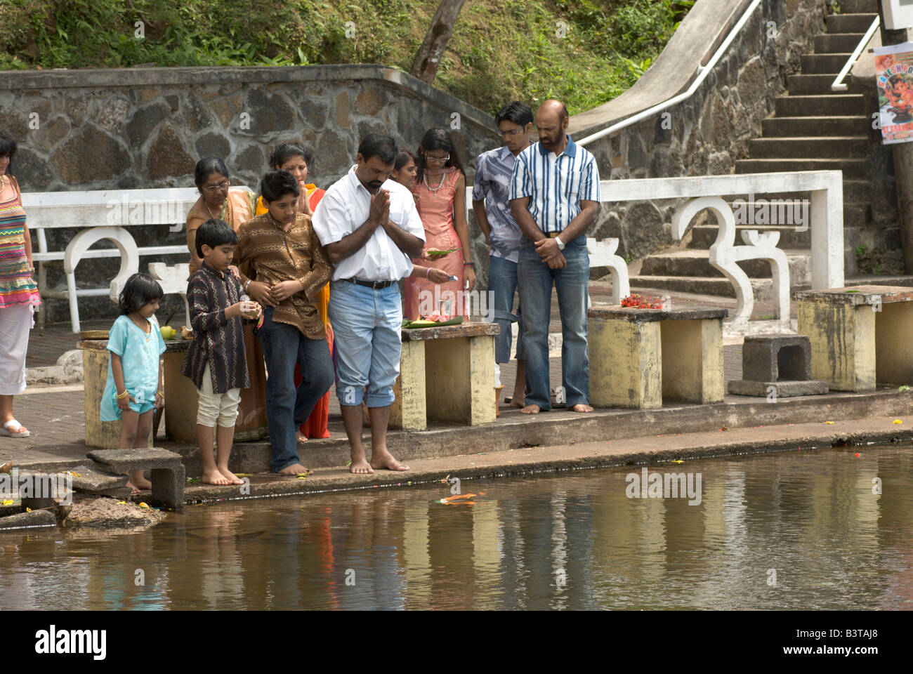 Mauritius, Ganga Talao, Grand Bassin. Hindu family make an offering ...