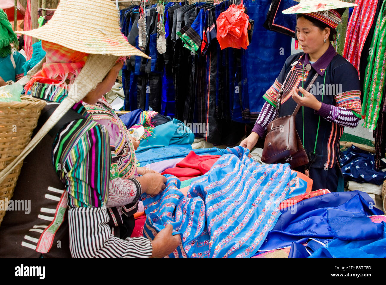 Asia, China, Yunnan Province, Yuanyang. Minority women shop for fabric ...