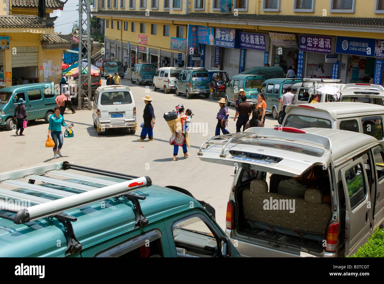 Asia, China, Yunnan Province, Yuanyang. Minivans are farmer ...