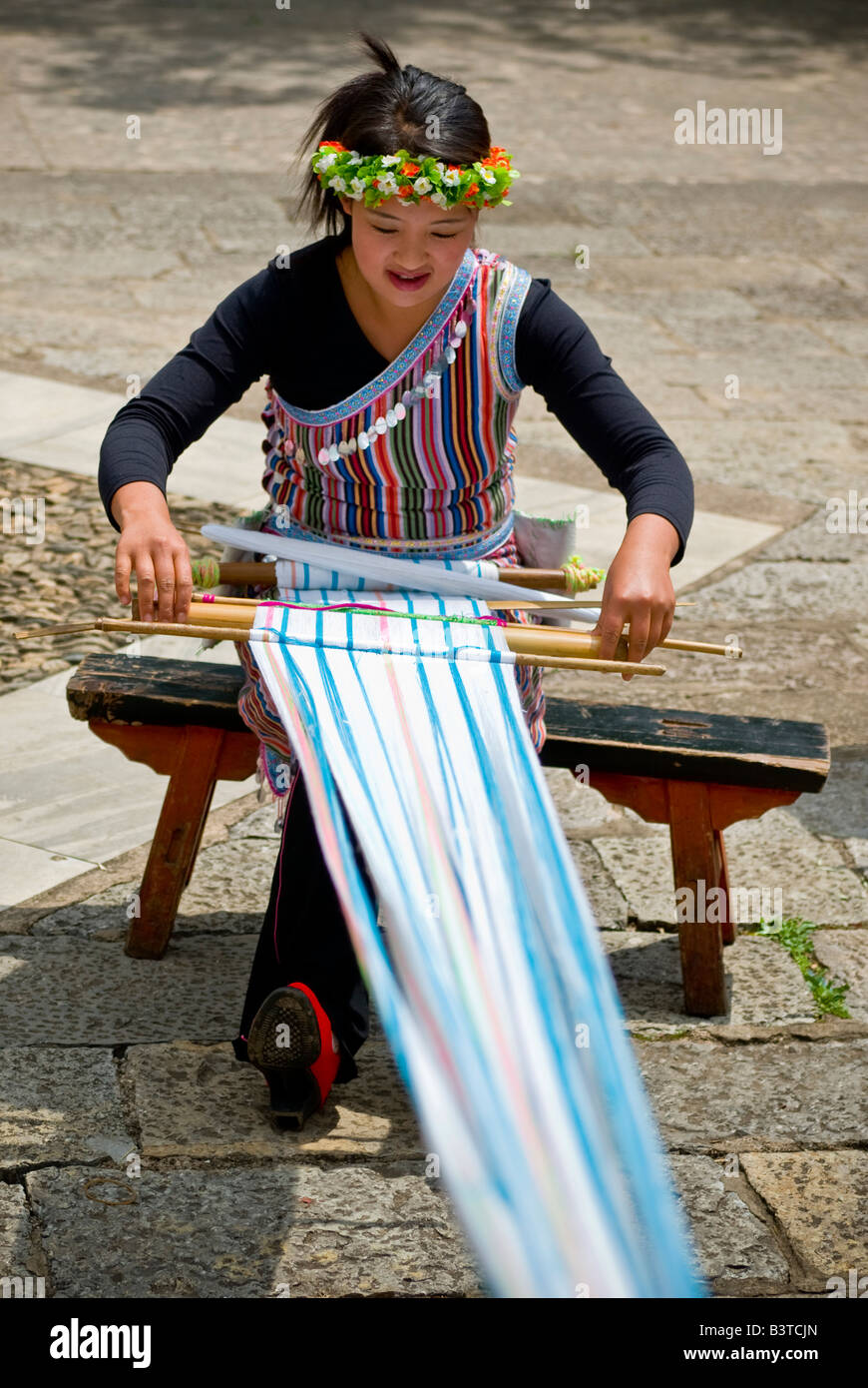 Asia, China, Yunnan Province. Back-strap weaving practiced by young ...