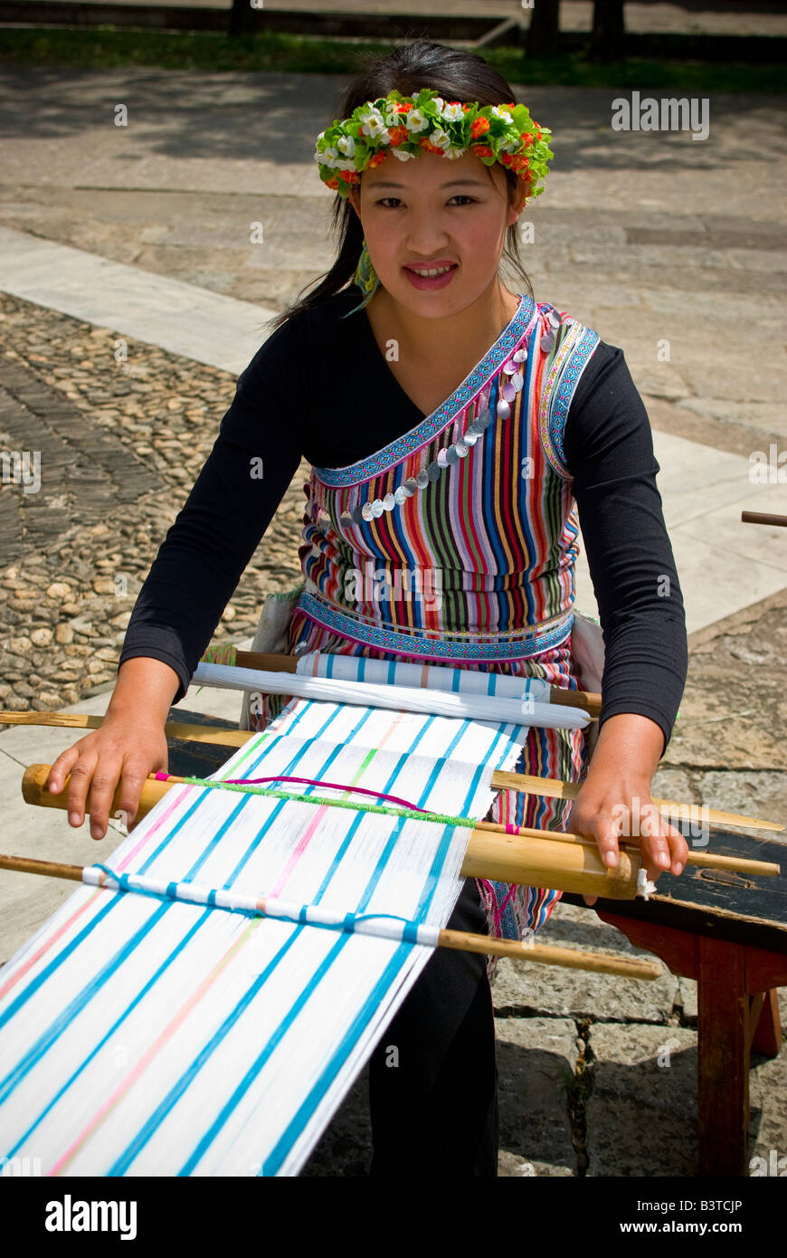 Asia, China, Yunnan Province. Back-strap weaving practiced by young ...