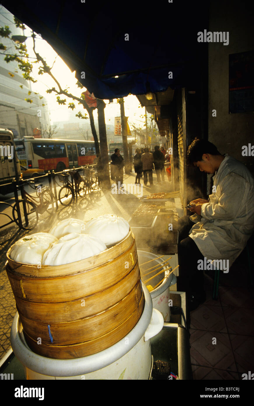 Dumpling seller dialing his cell phone at an open air dumpling shop in ...