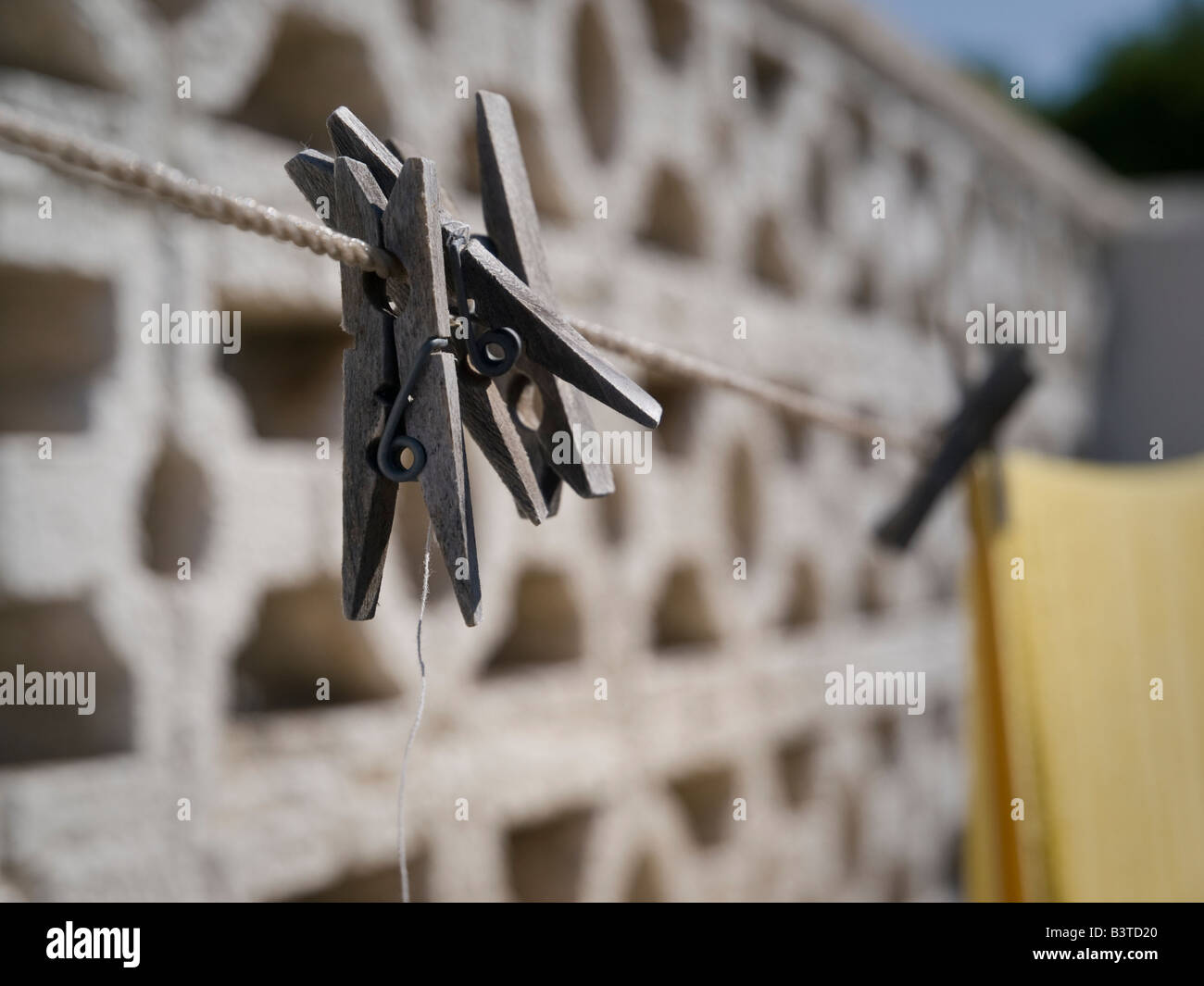 Clothes pegs with yellow towel in background drying in the sun Stock ...