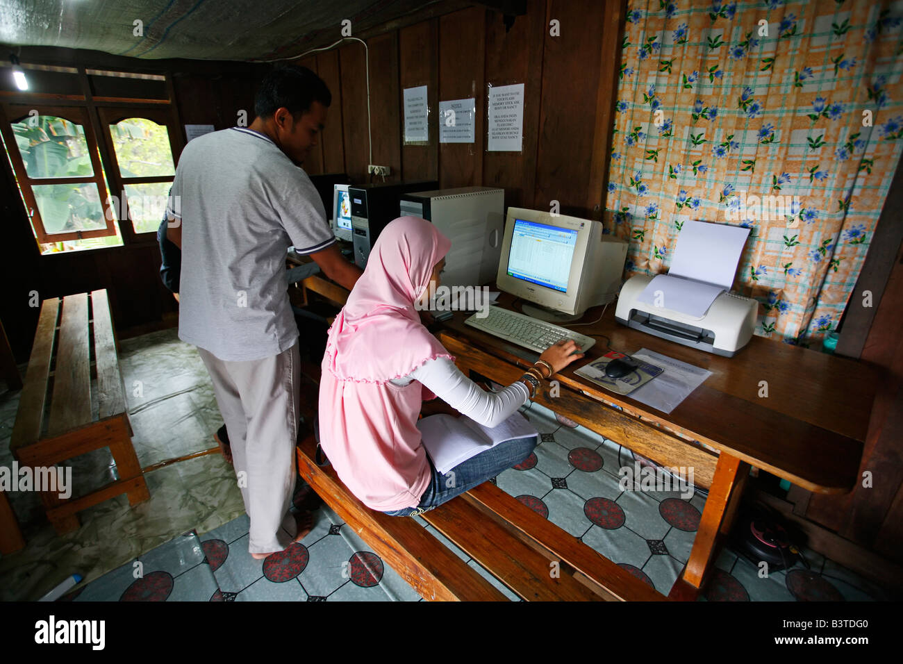 Indonesia. Muslim girl and teacher at computer in a basic school Stock ...