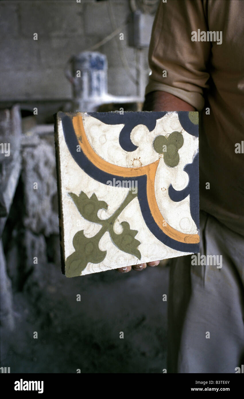Asia, Israel, West Bank, Ramallah. Tile maker displaying crafted tile ...