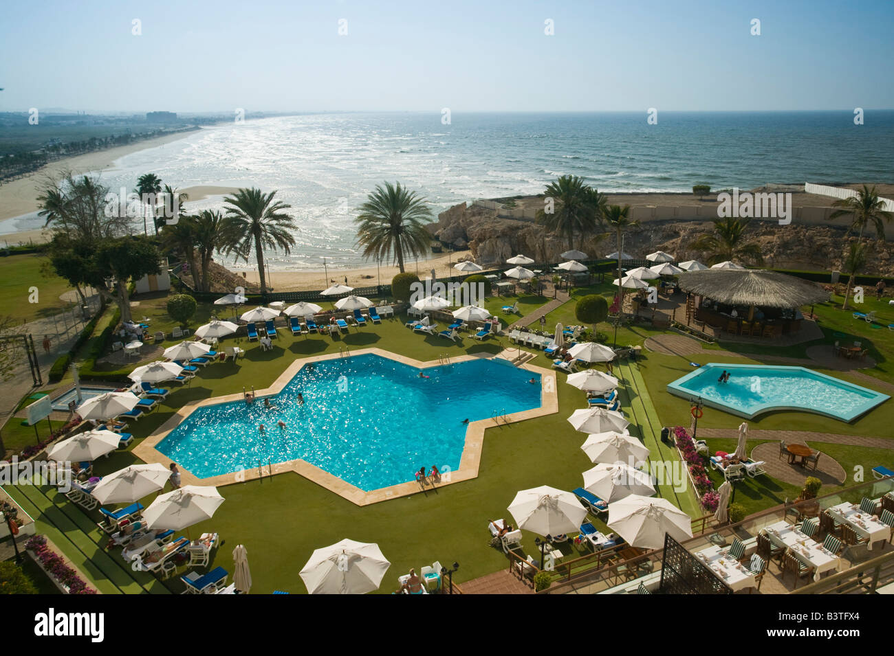 Oman, Muscat, Qurm. Crowne Plaza Hotel Pool and Qurm Beach Stock Photo ...