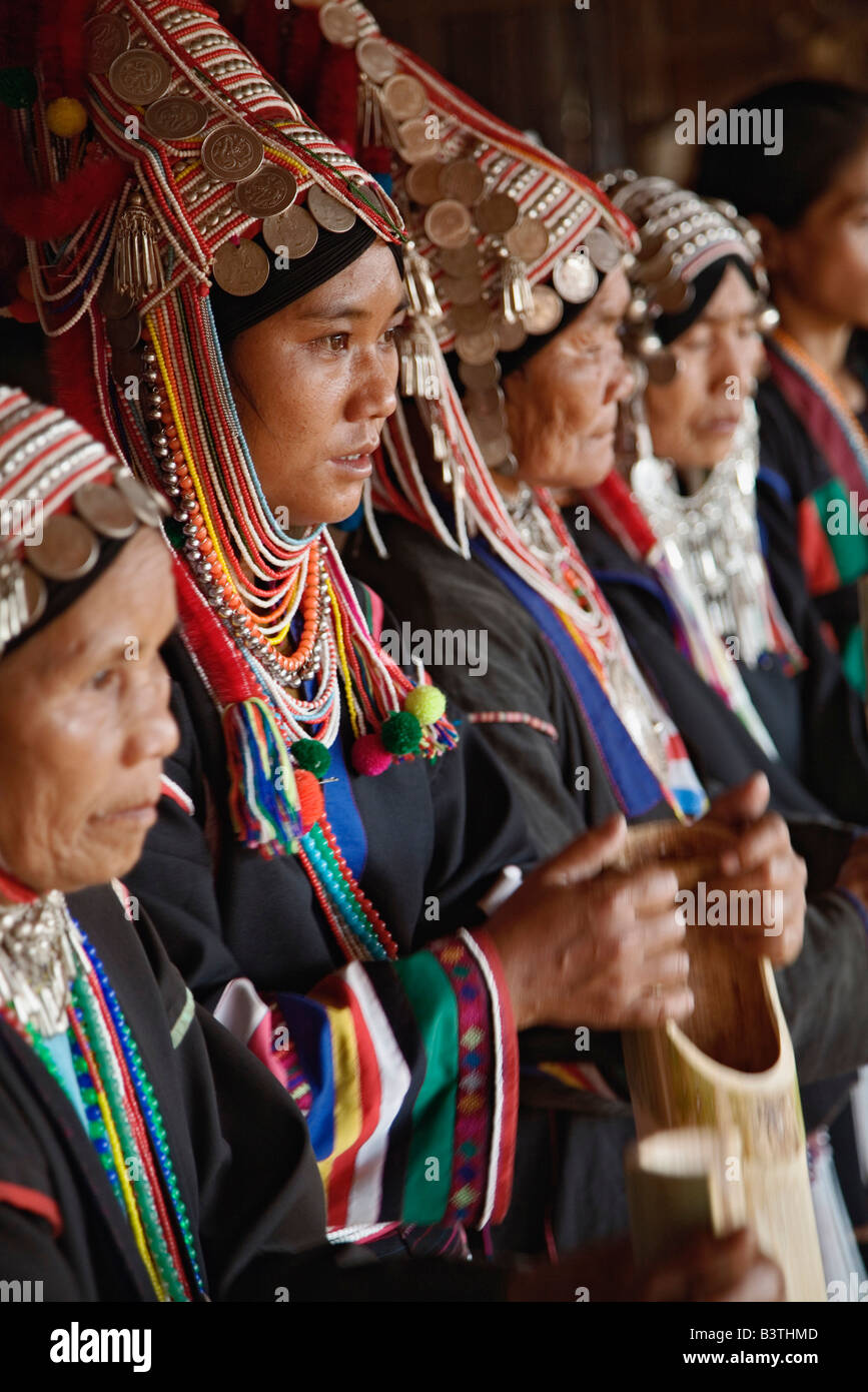 Akha hilltribe women wearing ornate headress performing traditional ...
