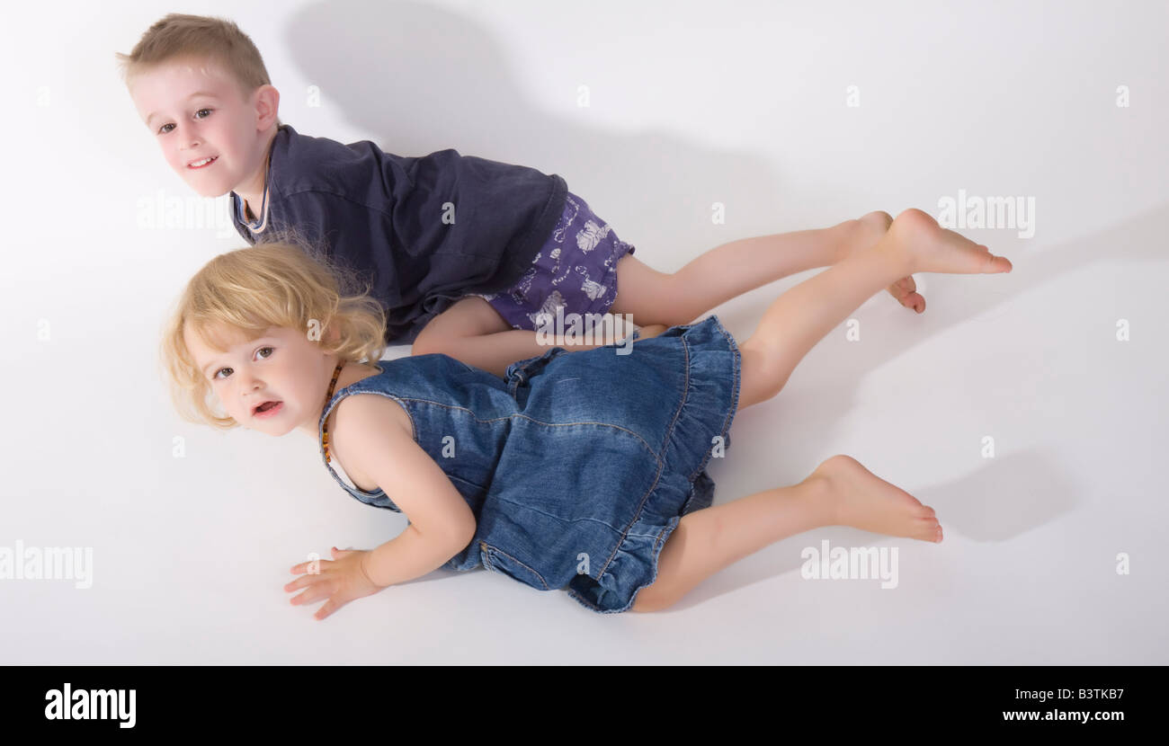 children lying and playing on the floor Stock Photo - Alamy