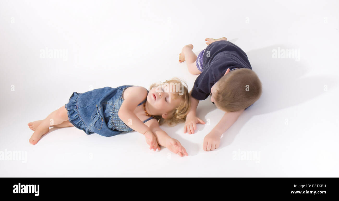 children lying and playing on the floor Stock Photo - Alamy