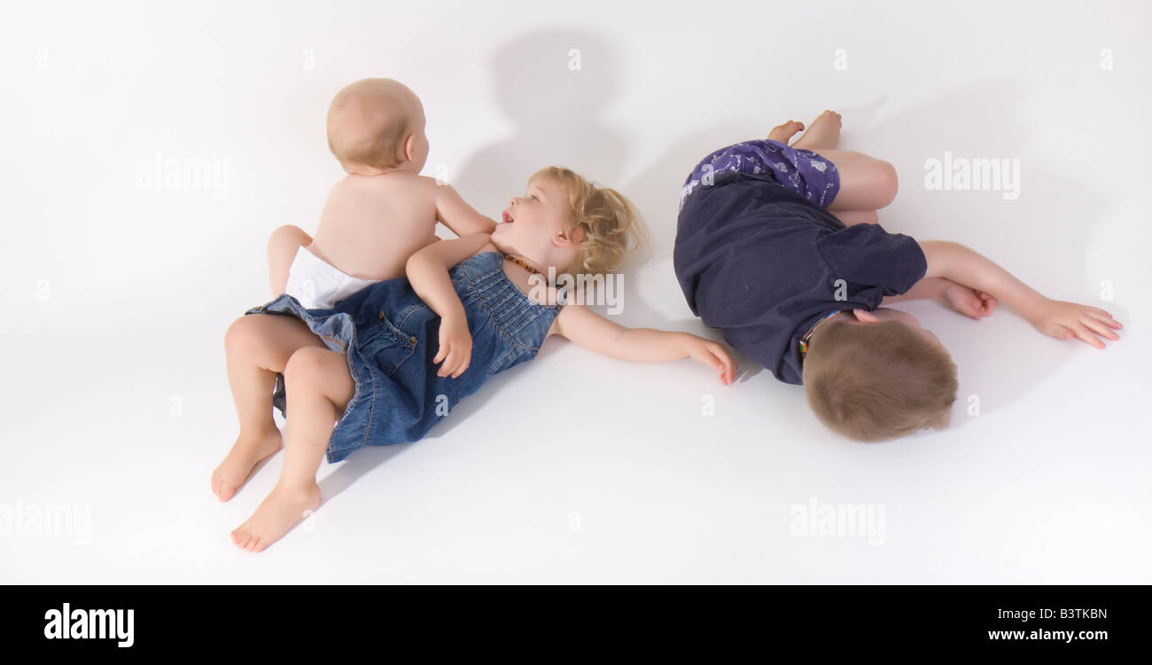 children lying and playing on the floor Stock Photo - Alamy