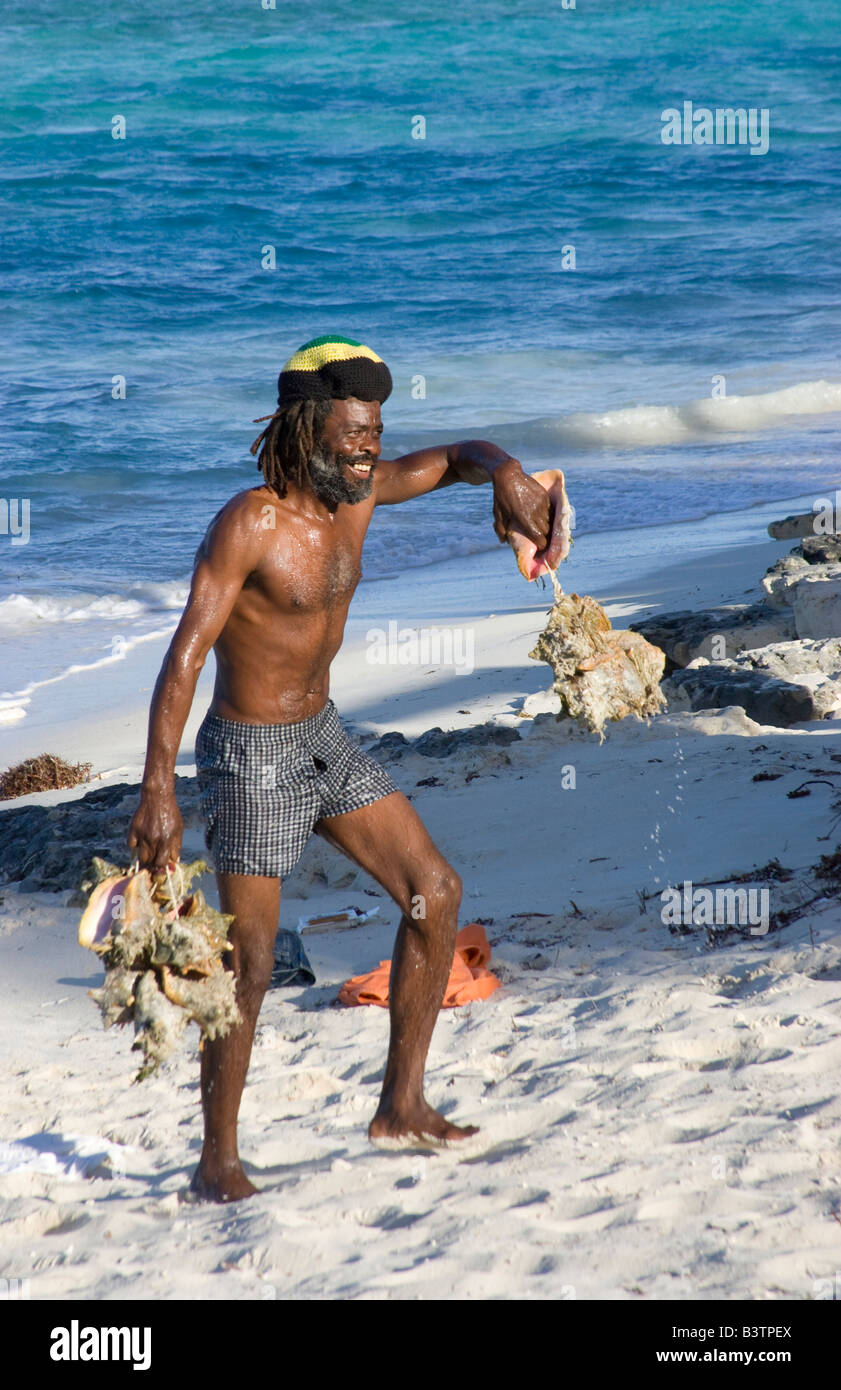 Bahamas, Exuma, Georgetown. Bahamian fisherman with harvested conch ...