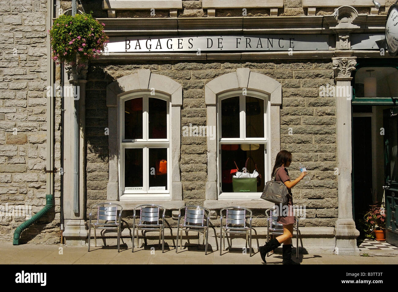 North America, Canada, Quebec, Old Quebec City. Woman passing by a ...