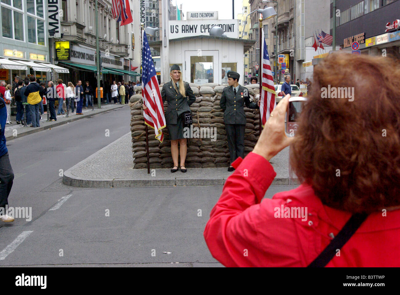 Europe, Germany, Berlin, redheaded woman photographing Checkpoint ...