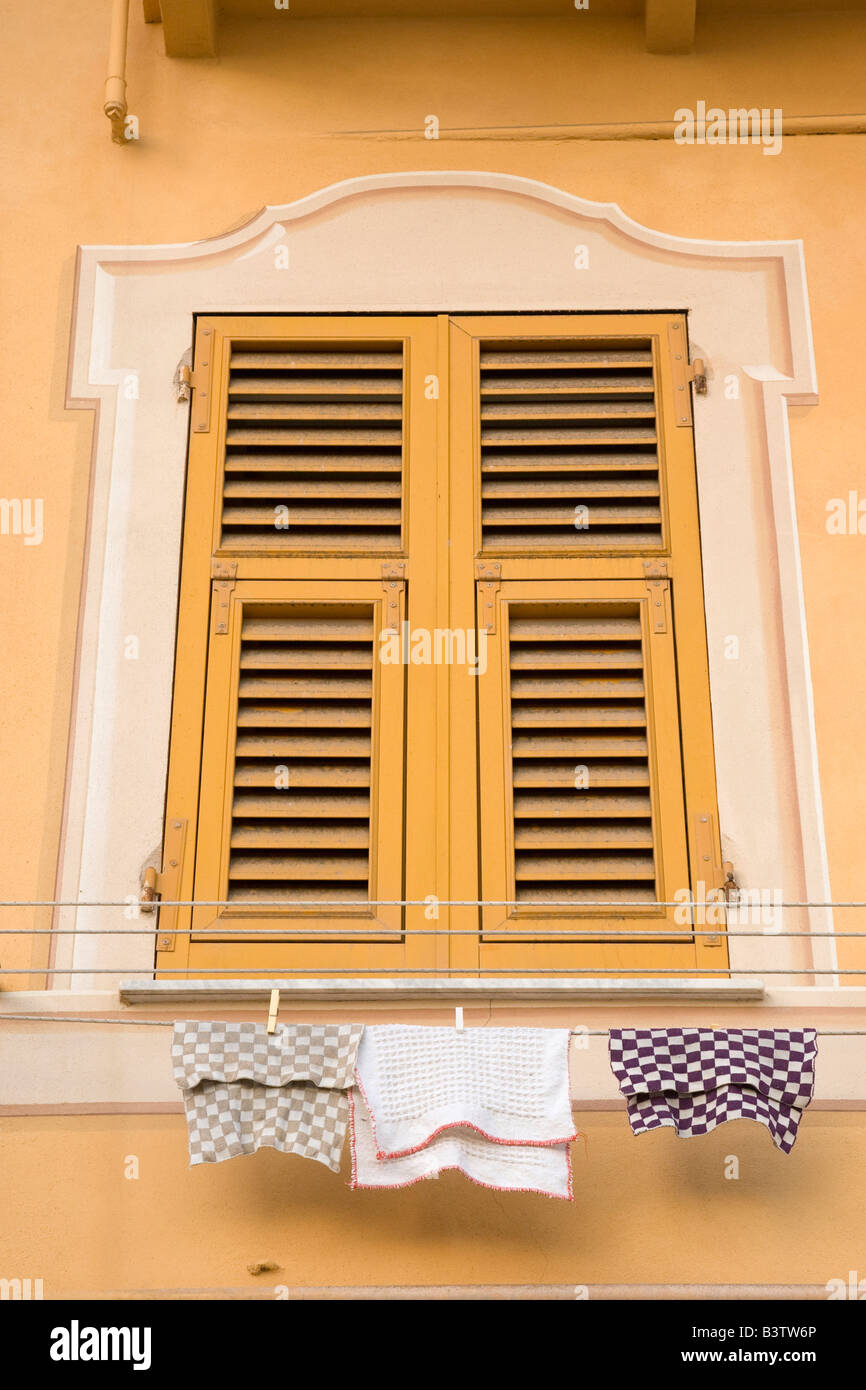 Europe, Italy, Camogli. Yellow shuttered window and laundry on clothesline Stock Photo - Alamy