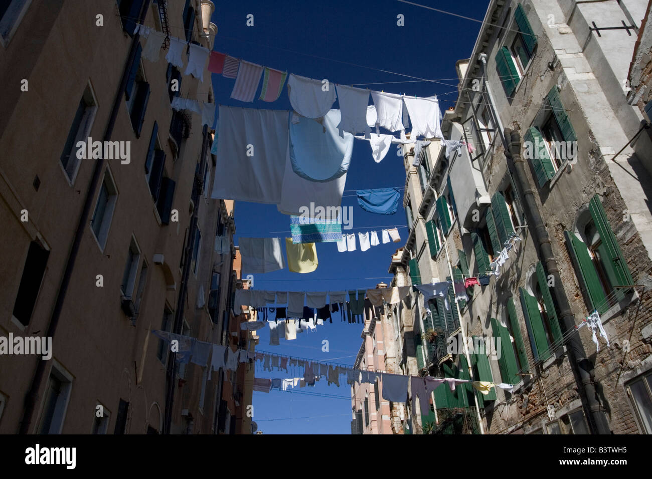 Europe, Italy, Venice. Laundry strung between buildings in the Ghetto ...