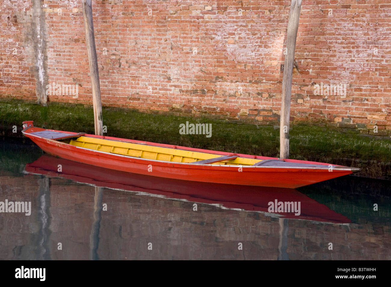 Europe, Italy, Venice. Red boat reflecting in canal's still water Stock ...