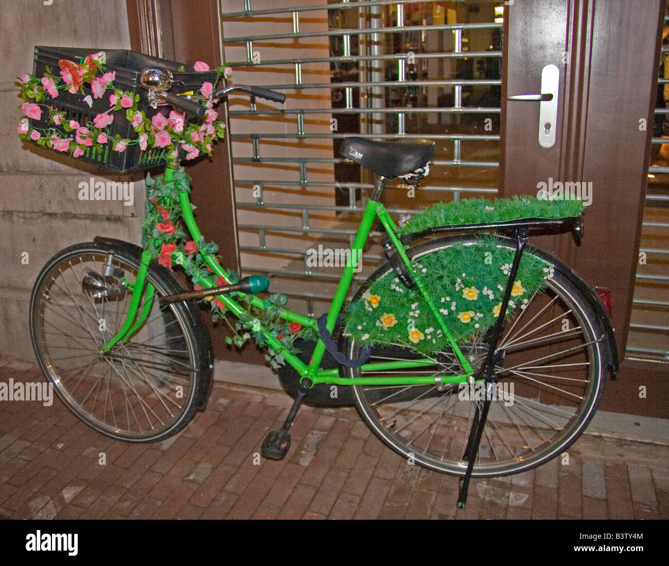 A brightly decorated green bicycle with colorful flowers Stock Photo ...