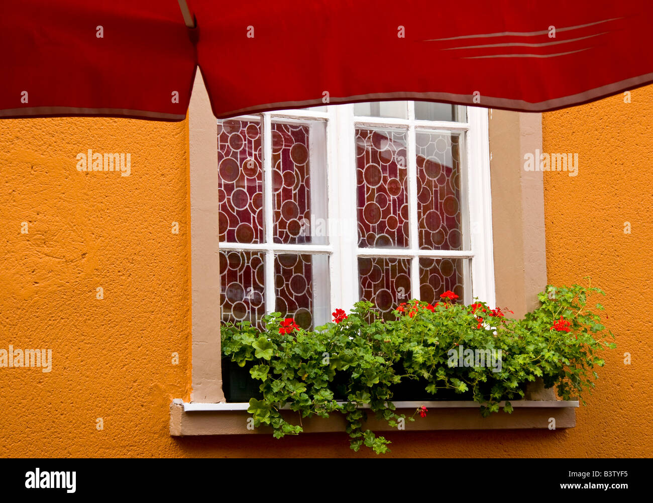Europe, Poland, Gdansk. Window detail with flower box under awning ...