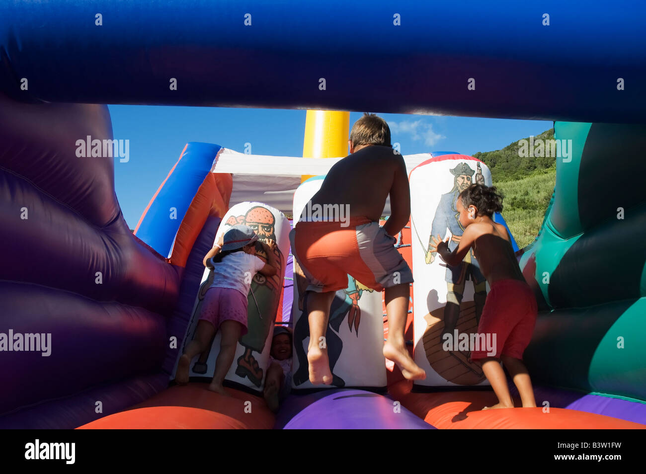 Kids playing inside a colourful bouncing boat Stock Photo - Alamy