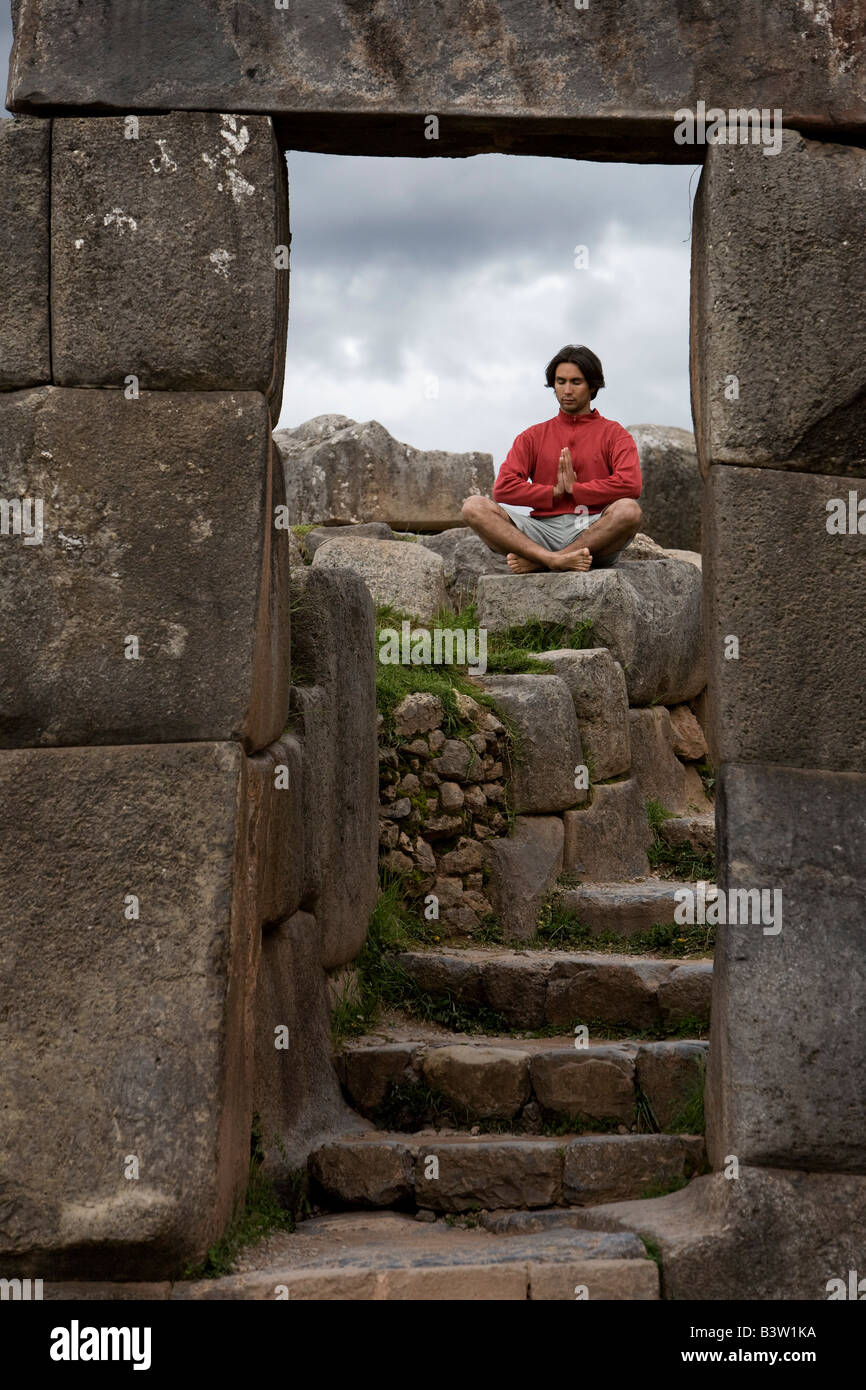 A young man meditates in ancient Incan ruins outside Cuzco, Peru Stock ...