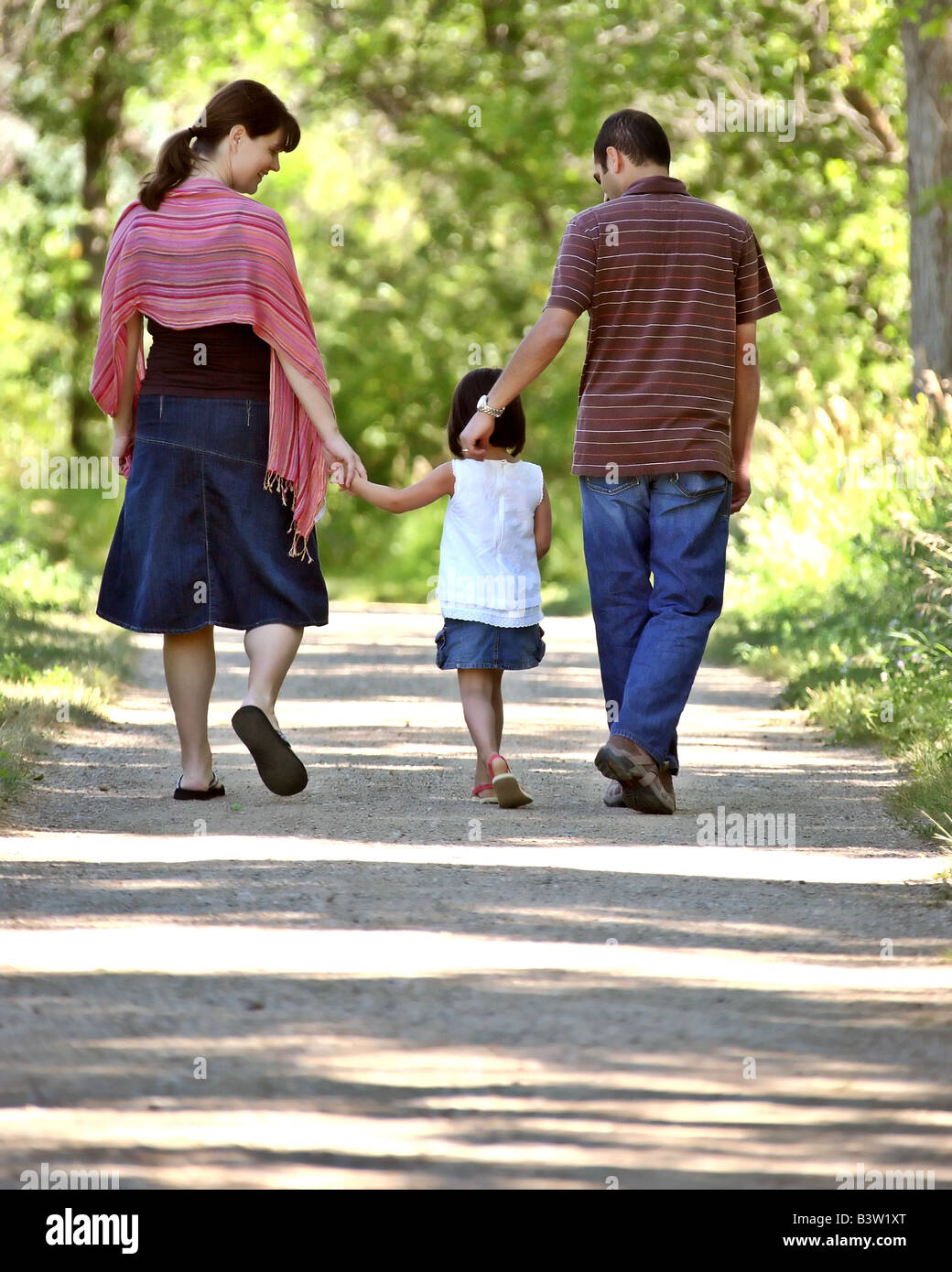 Family out for a walk in the park Stock Photo - Alamy